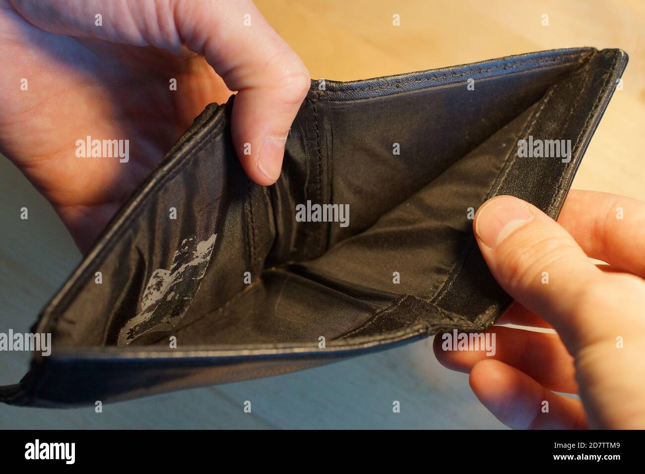 Closeup of a person opening an empty wallet - concept of crisis and ...