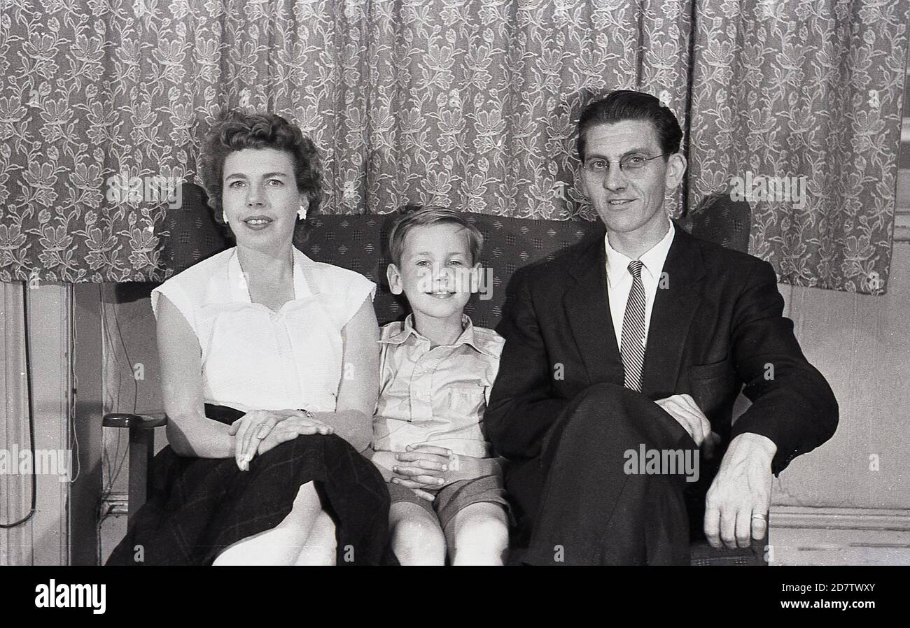 1950s, historical, family picture of a mother, father and son sitting ...