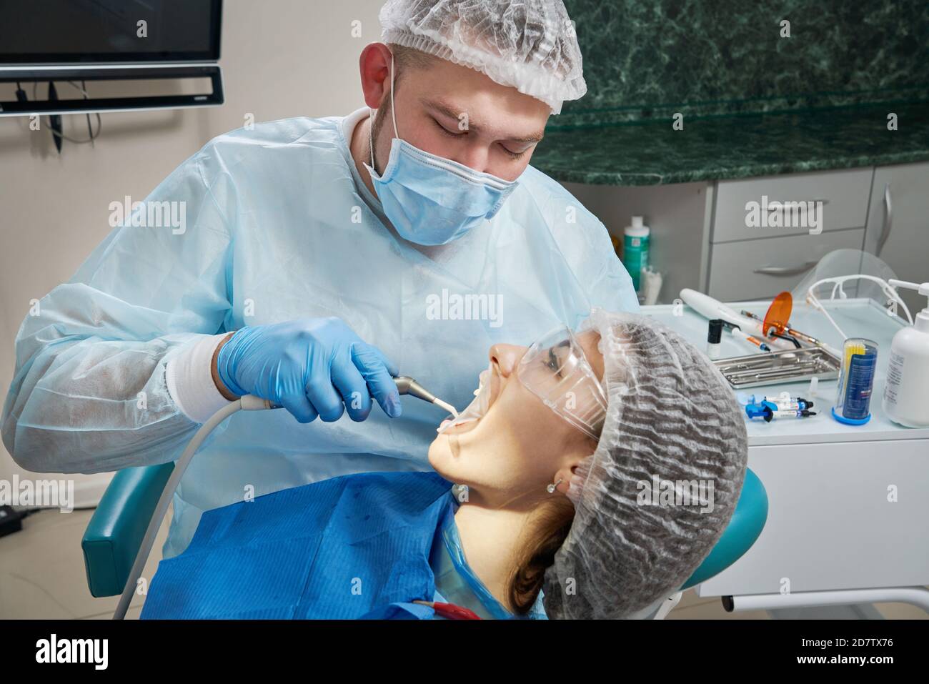 Dentist using air water spray during patient treatment Stock Photo - Alamy