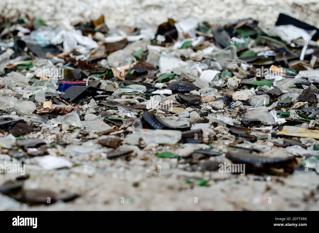 Random pieces of broken glass on the ground. Colored glass pieces mixed ...