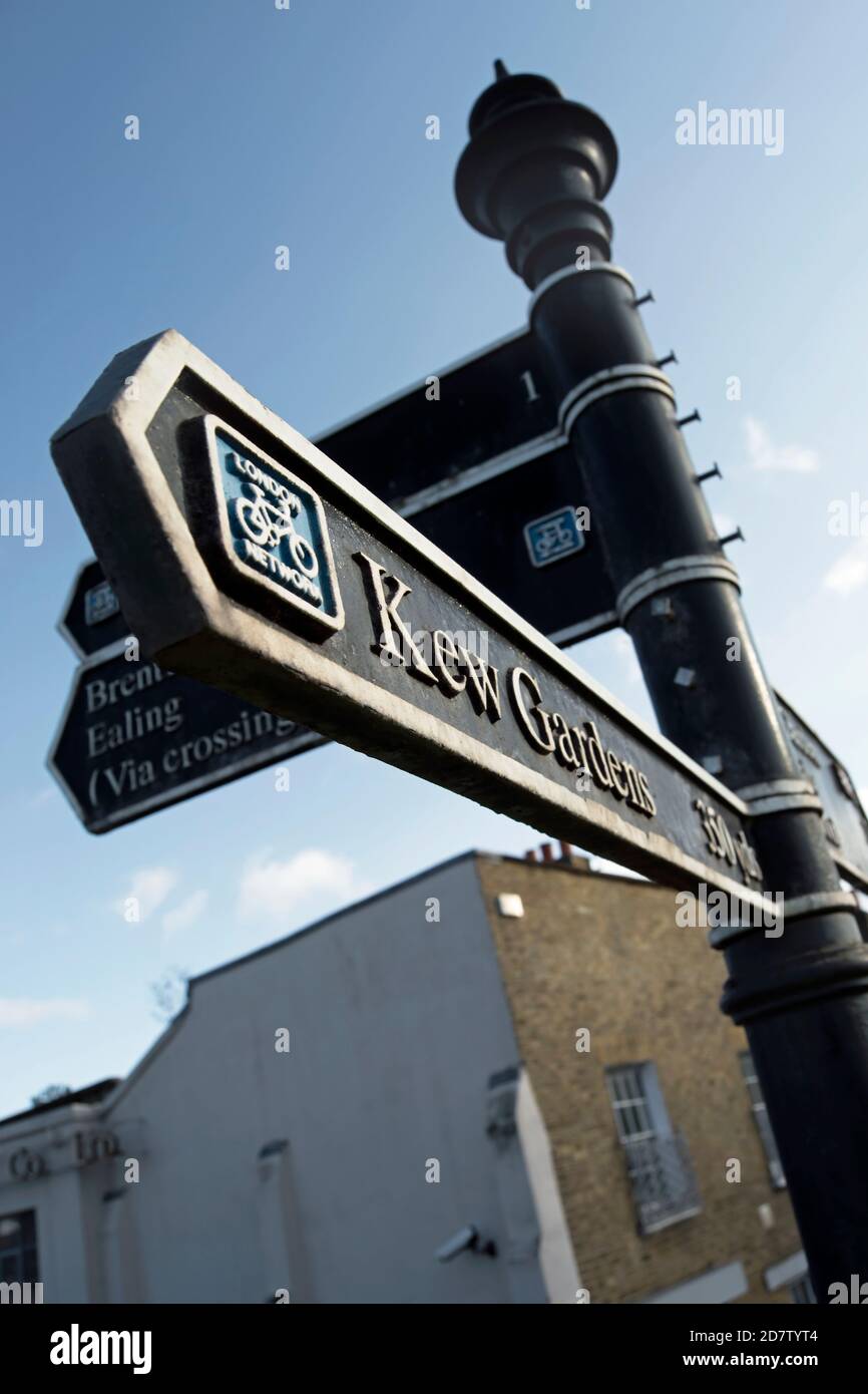 right pointing sign giving direction and distance to kew gardens, with ...
