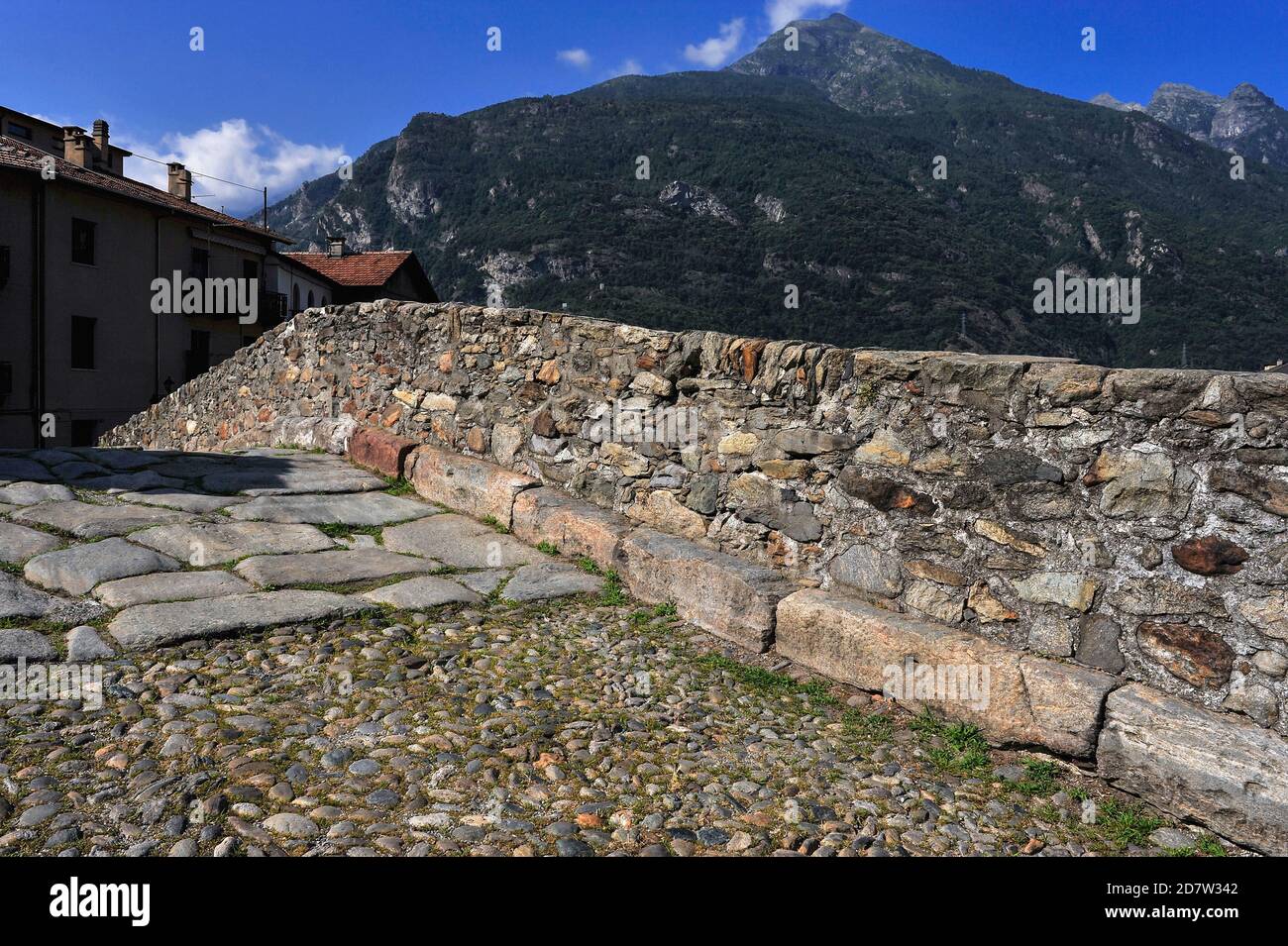 Cobbles and rutted flagstones pave roadway of Ponte Romano single-arch ...