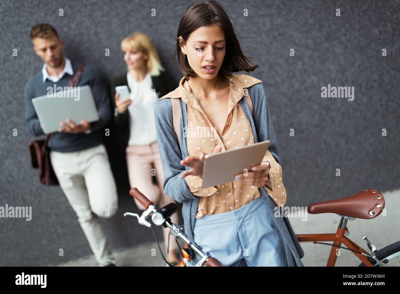 Group of business people using electronic devices outdoor Stock Photo ...