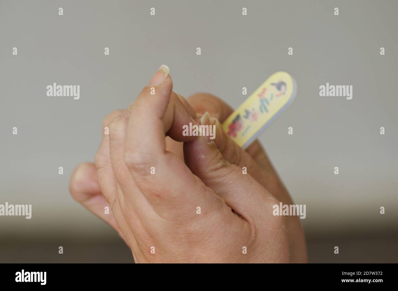 Female filing and painting her nails Stock Photo - Alamy
