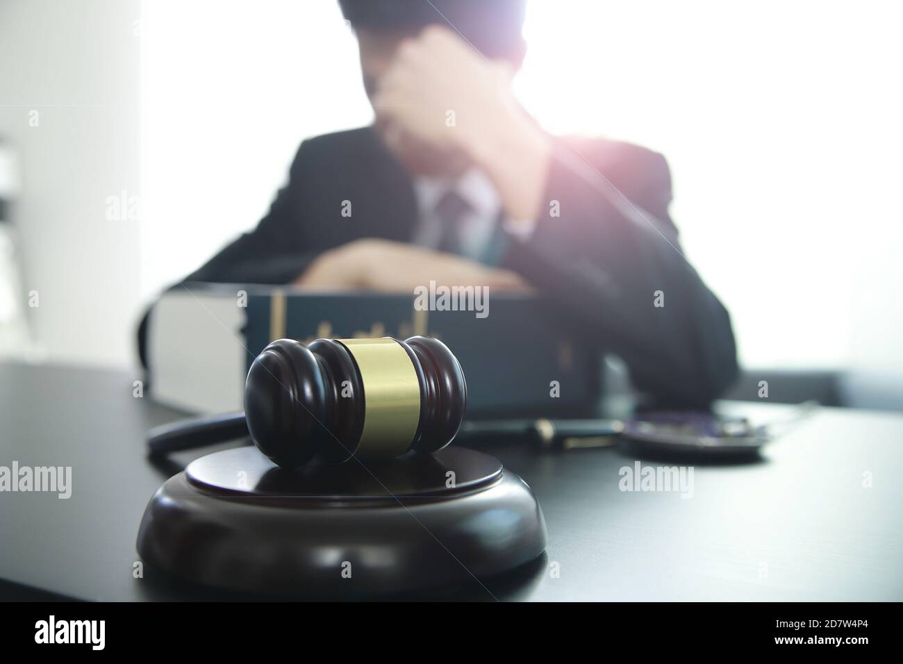 Tired lawyer sitting on desk Stock Photo - Alamy
