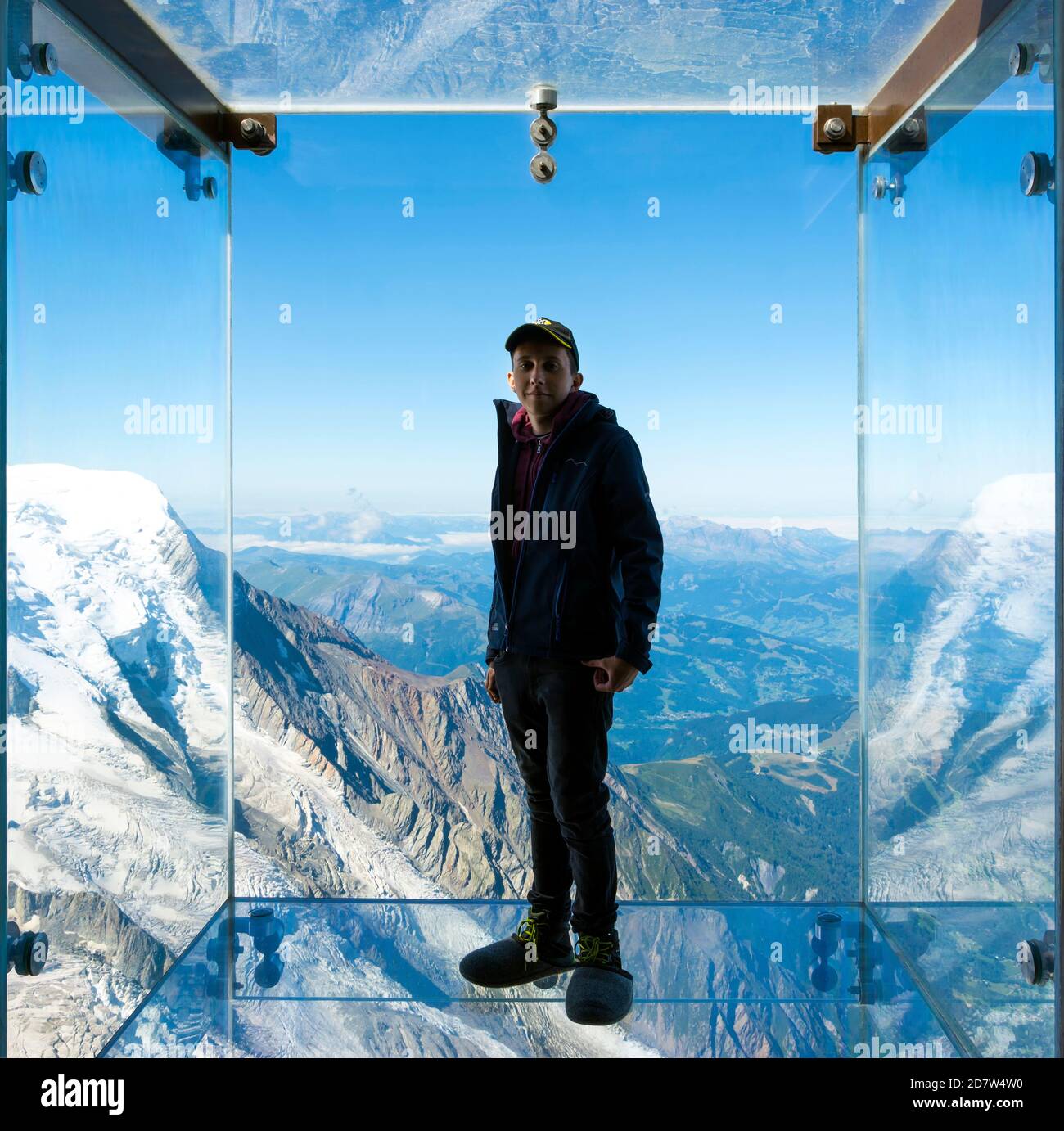 Tourist stands in the 'Step into the Void' glass box on the Aiguille Du ...