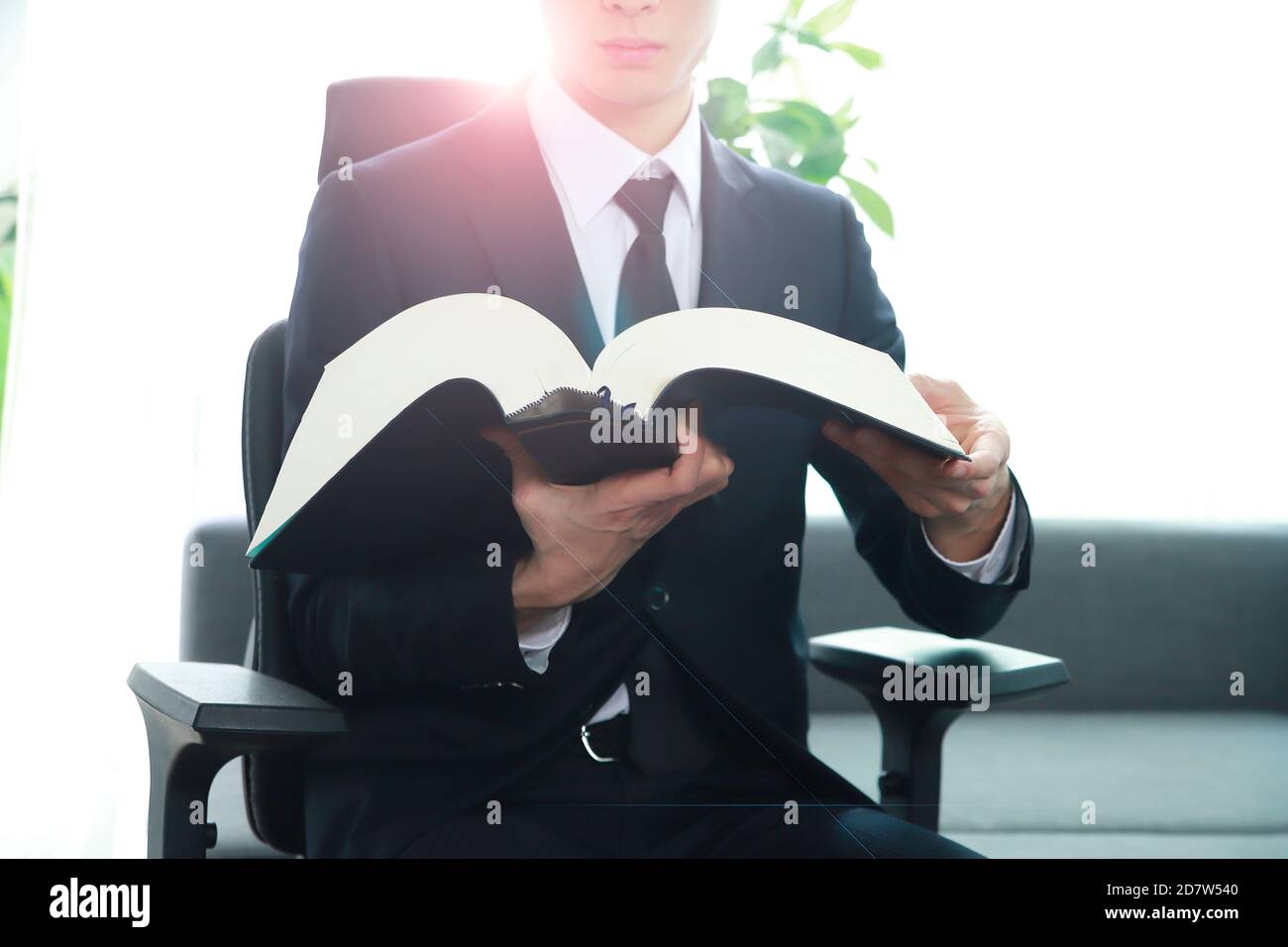 Lawyer reading law book in office Stock Photo - Alamy