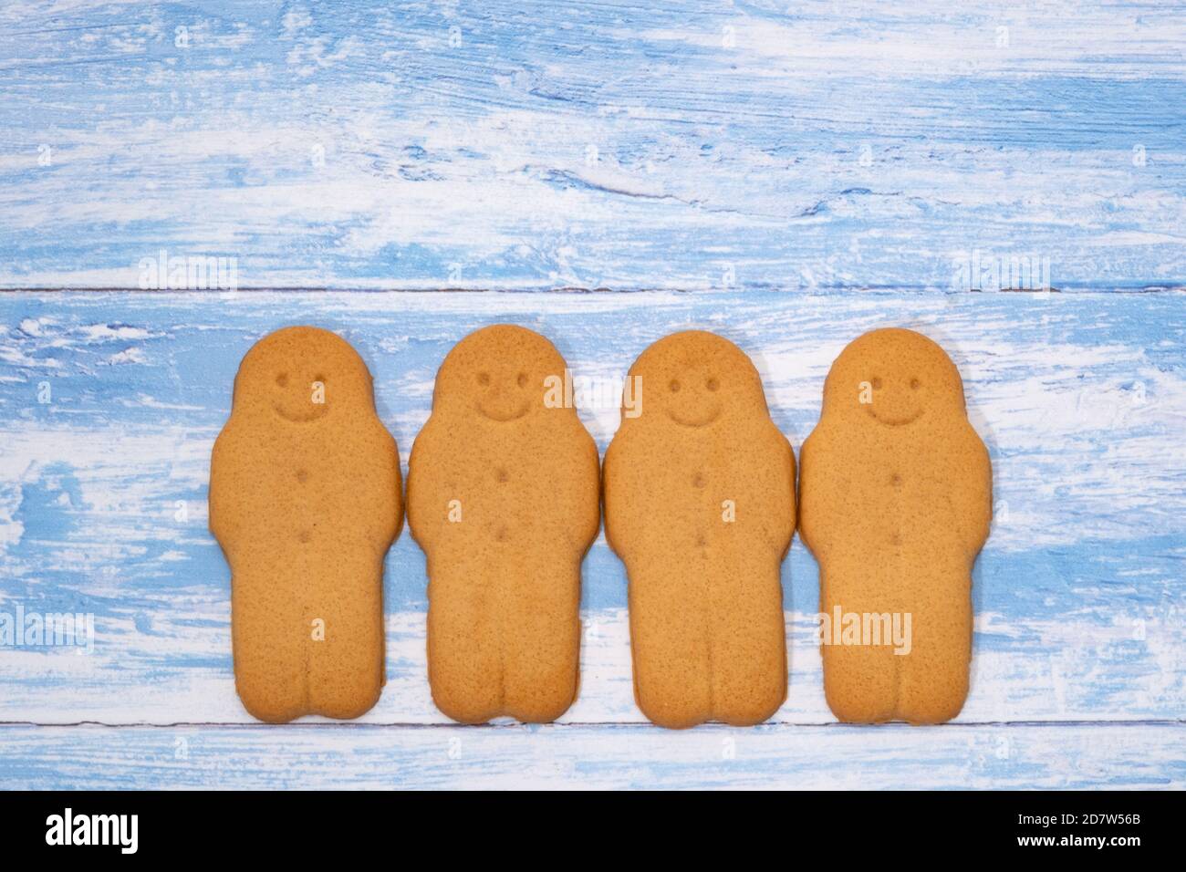A row of gingerbread men on a rustic blue background Stock Photo - Alamy