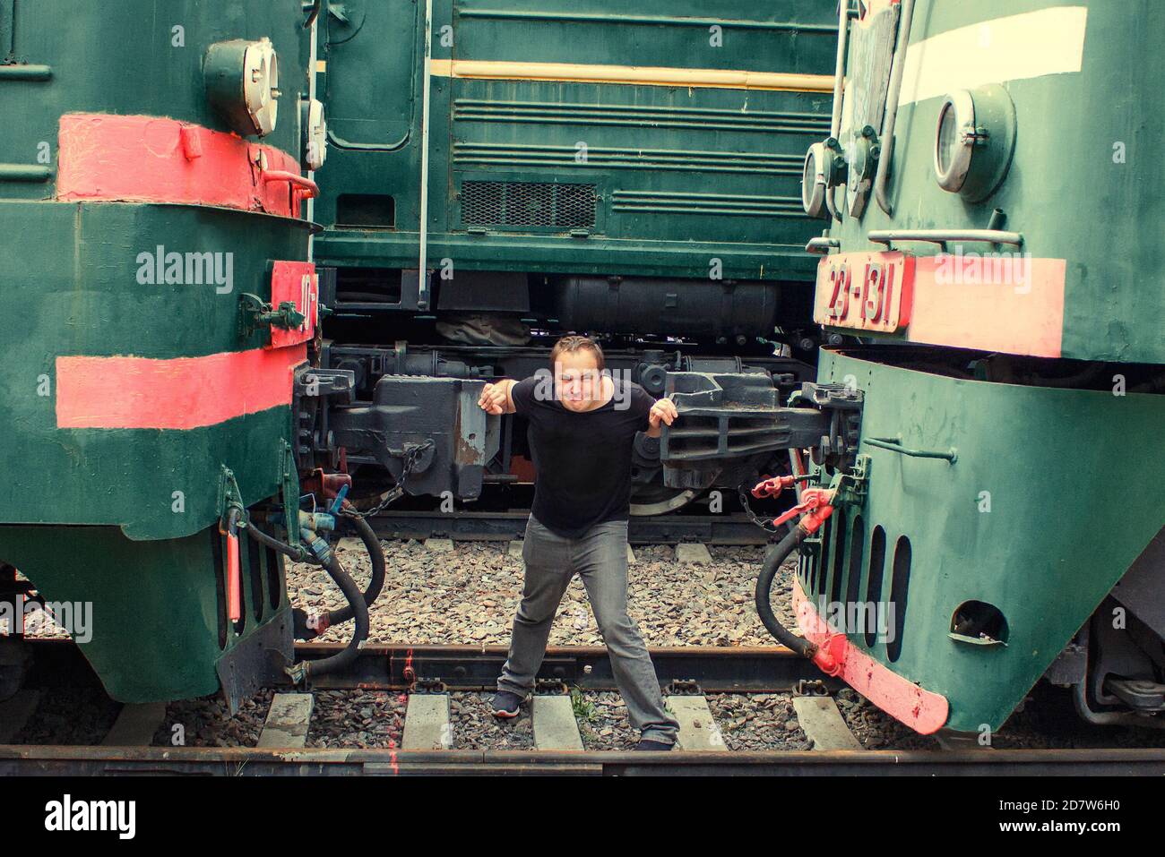A man between two trains. Resistance to mechanical engineering. human ...