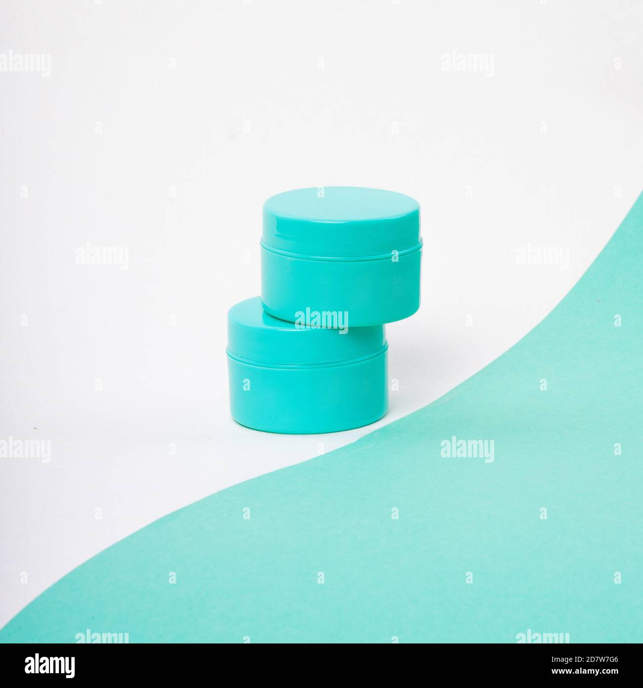 Two containers of mint color on a mint white background Stock Photo - Alamy