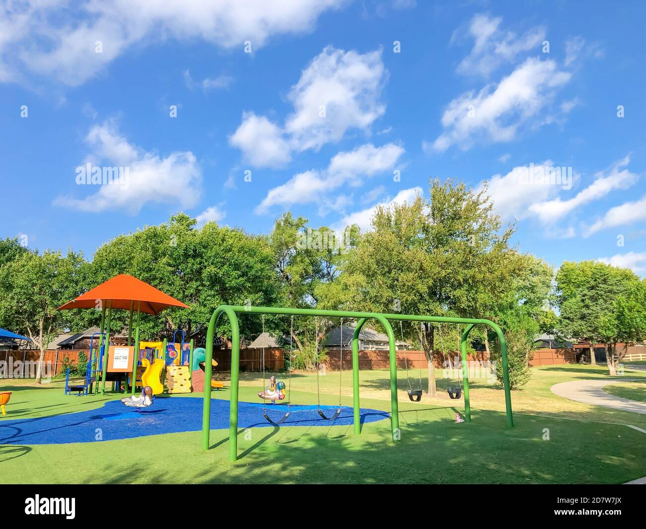 Residential area playground with sun shade sails and artificial grass ...