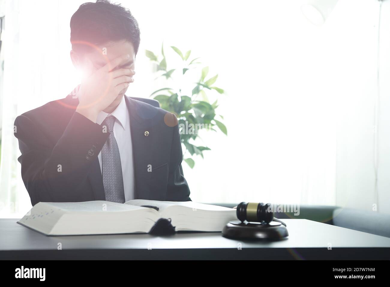 Tired lawyer sitting on desk Stock Photo - Alamy