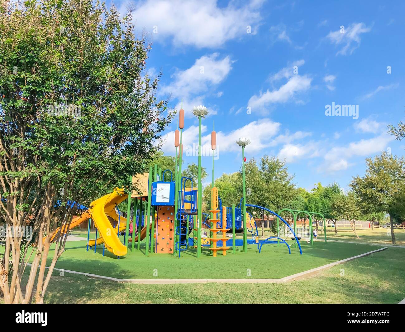 Residential area playground with sun shade sails and artificial grass ...