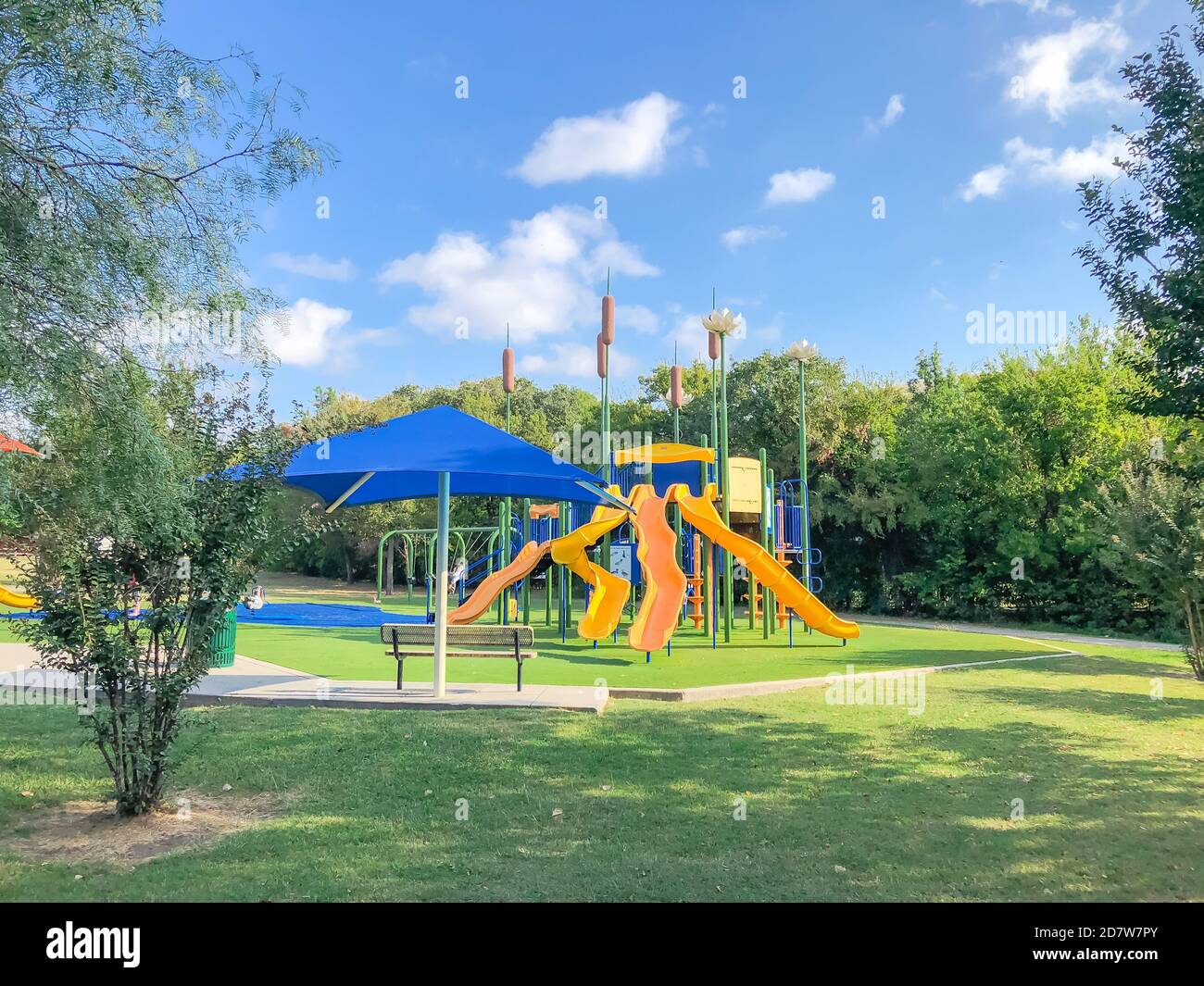 Residential area playground with sun shade sails and artificial grass ...