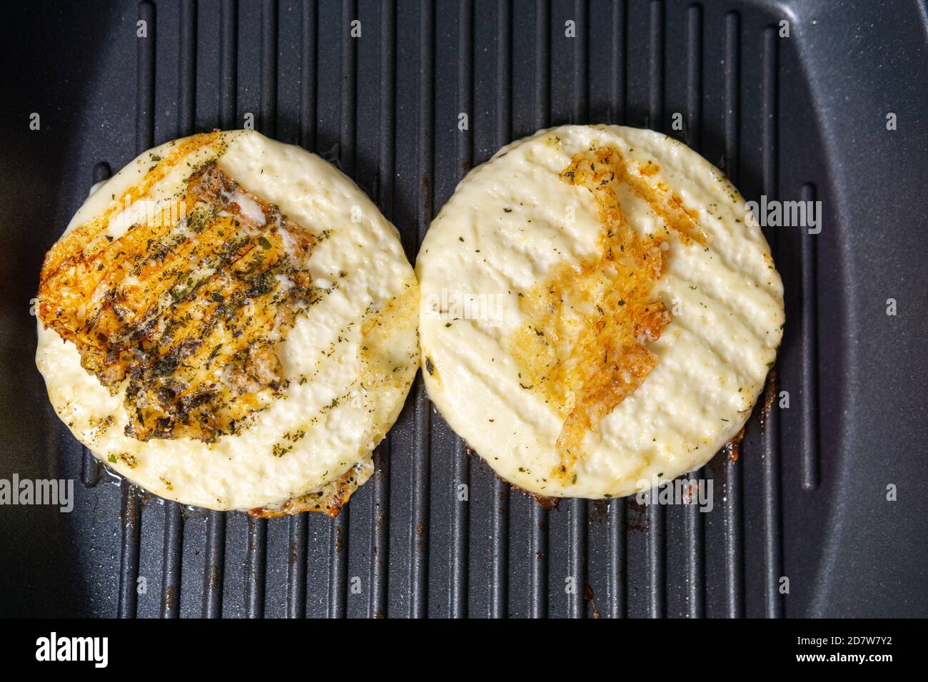 Grilled haloumi cheese with herbs on a grill pan. selective focus Stock ...