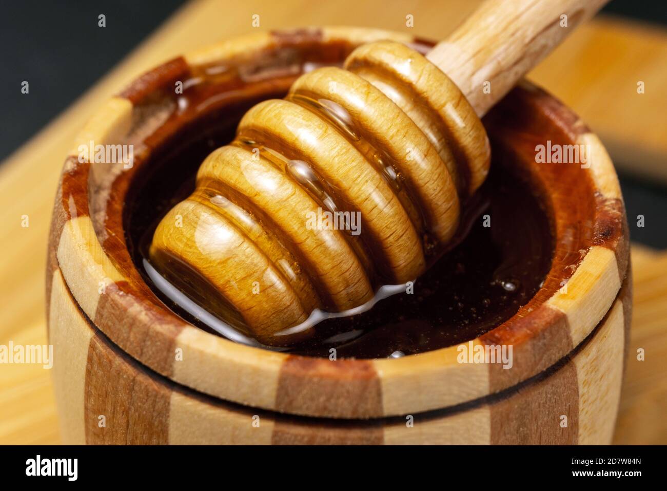 bucket of collecting from a jar of honey. Jars of honey. close-up macro ...