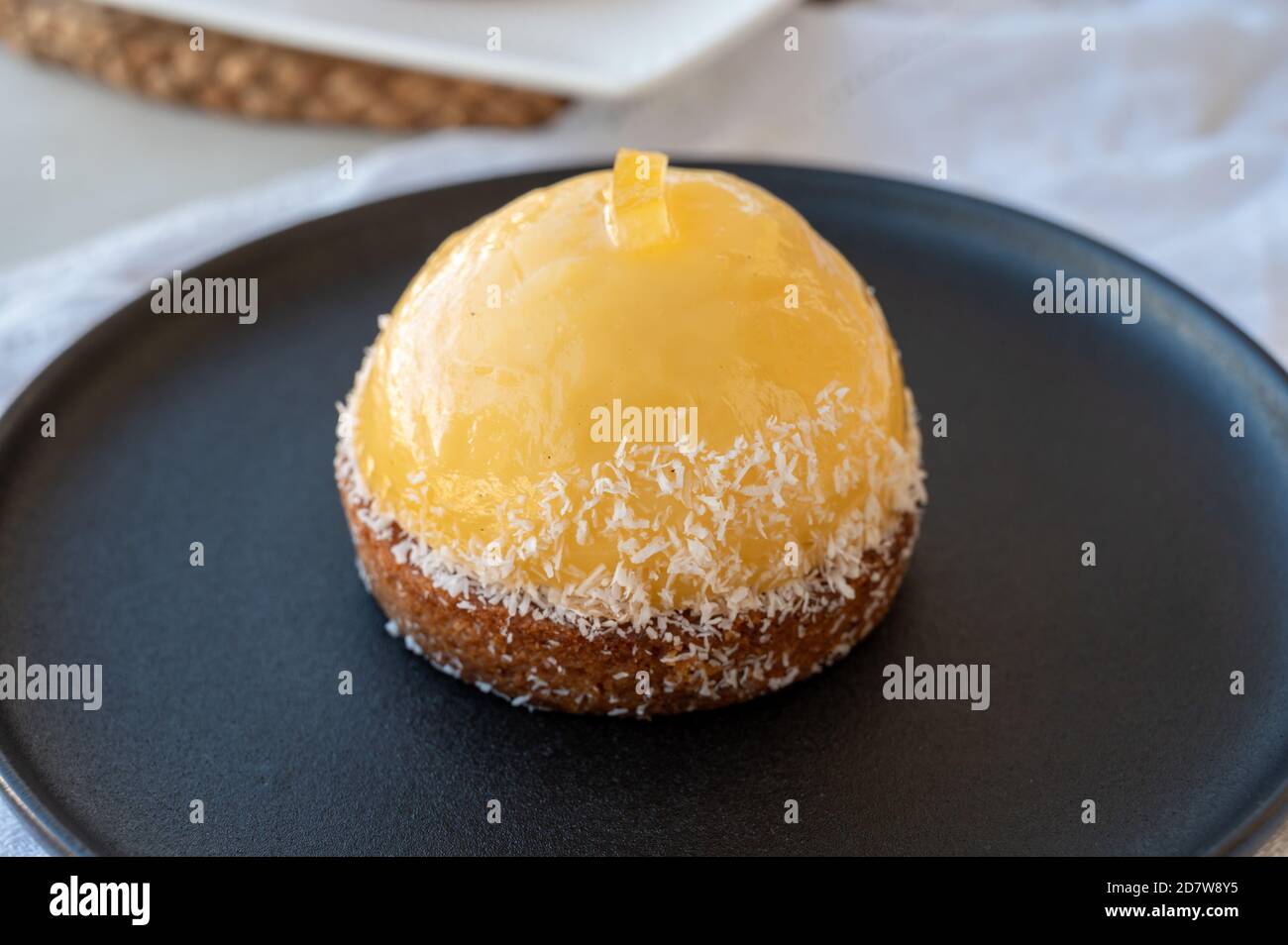 Small yellow lemon ball tart from French pastry shop close up Stock ...