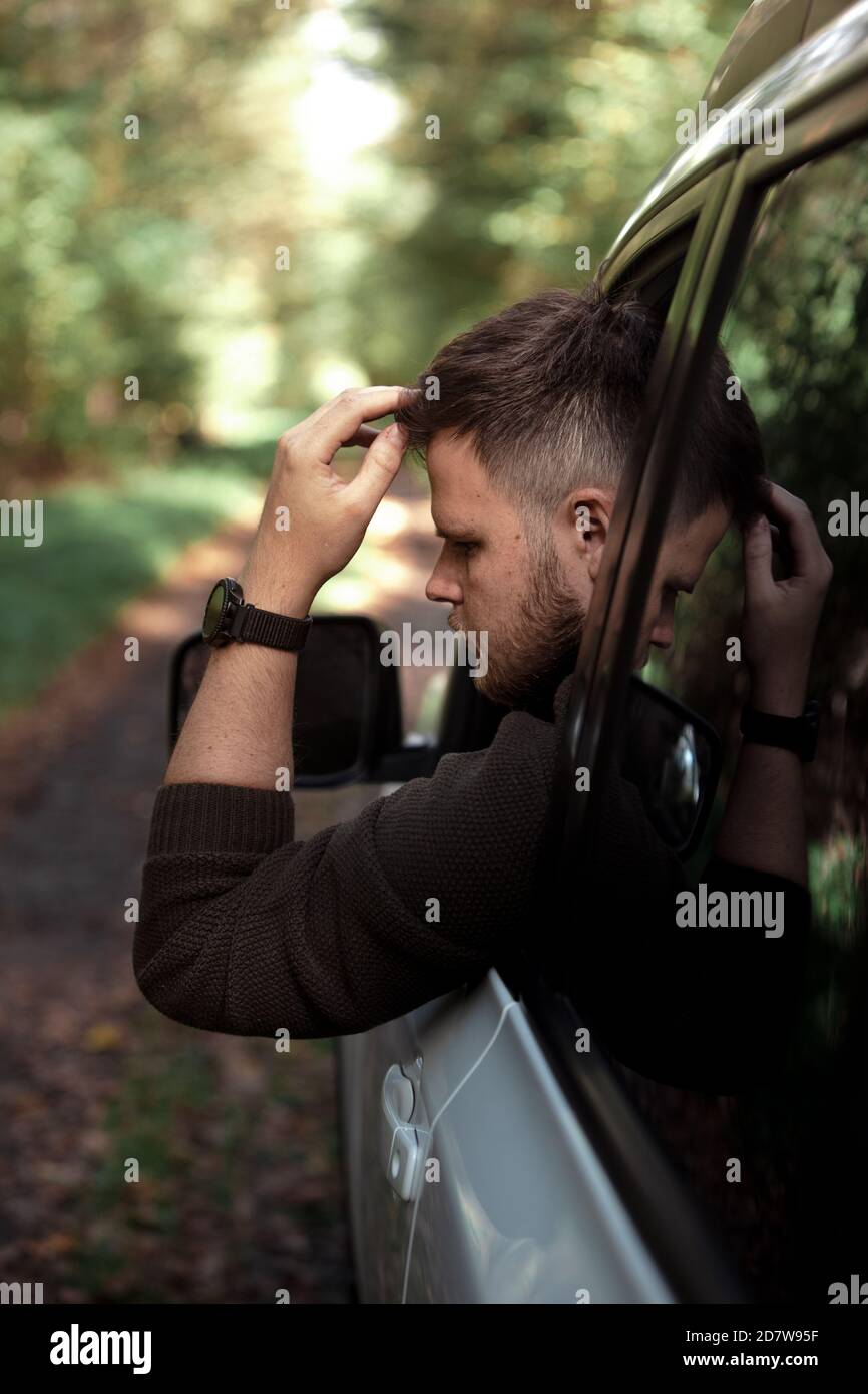 portrait of a man stick out of car window Stock Photo - Alamy