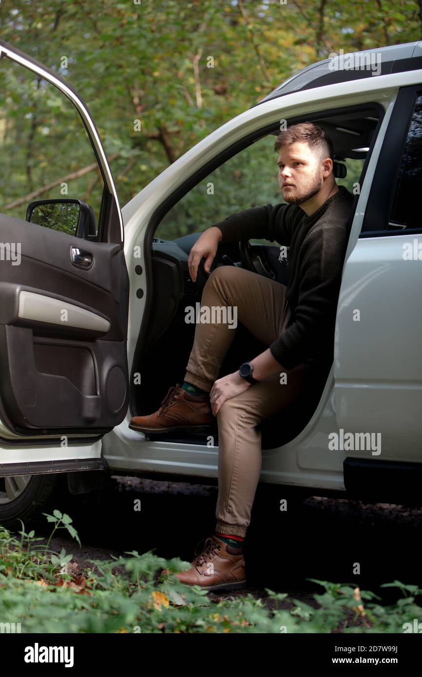 man goes out of car open doors Stock Photo - Alamy