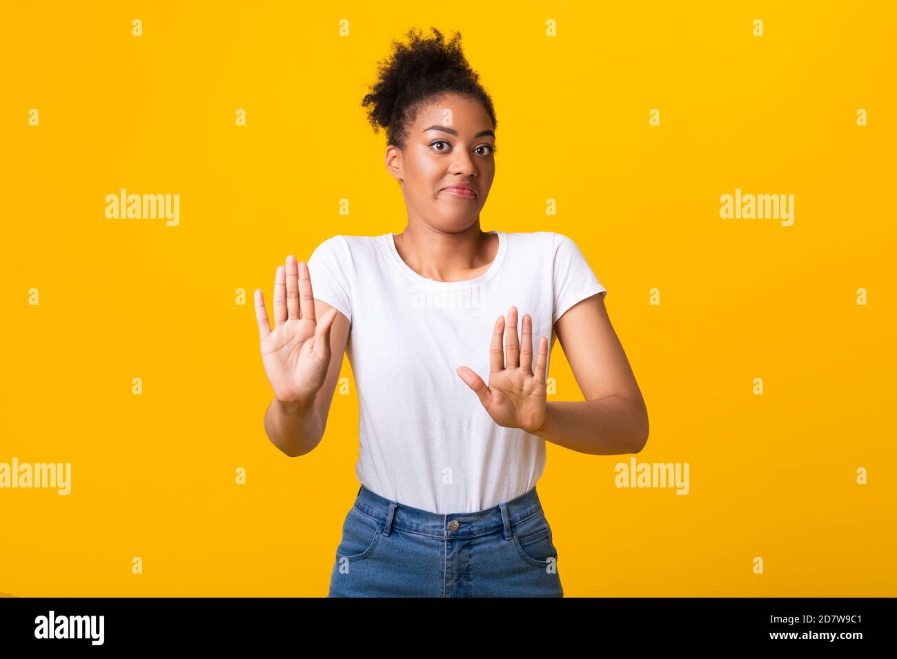 Serious balck lady showing stop sign with hands Stock Photo - Alamy