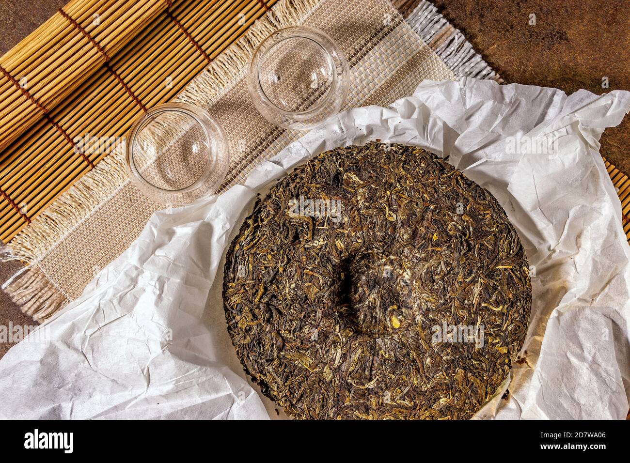 old Shen puerh chinese fermented tea on papyrus paper background. Top ...