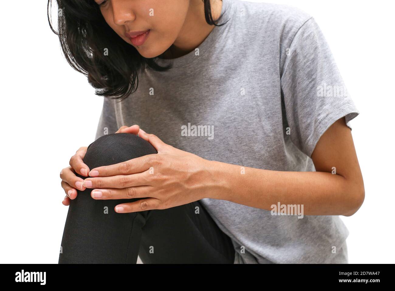 Woman having knee pain isolated on a white background Stock Photo - Alamy
