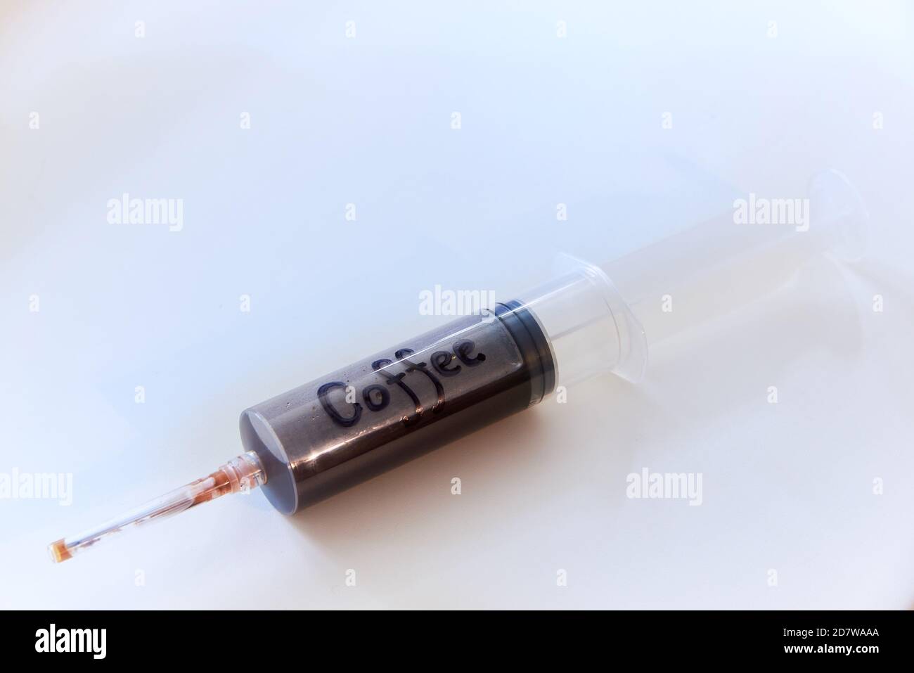 Syringe filled with coffee on white background, coffee addiction ...