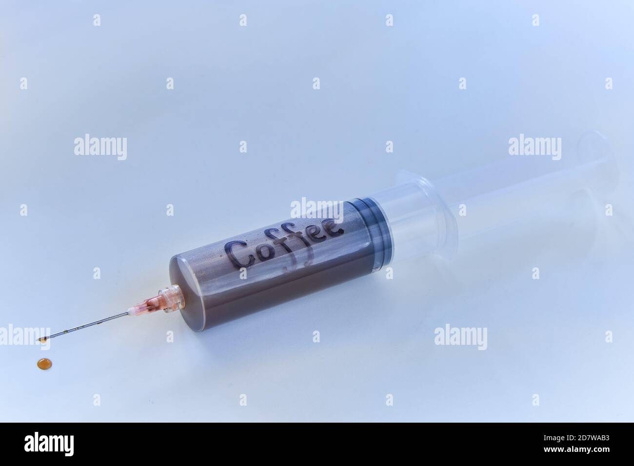 Syringe filled with coffee on white background, coffee addiction ...