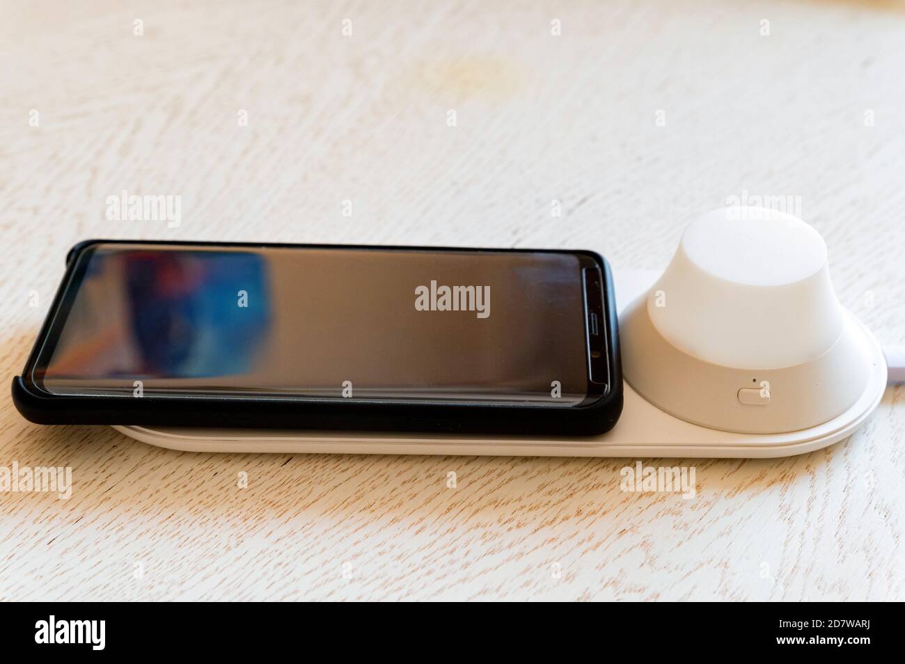 White modern wireless mobile device charger with mobile phone Stock ...