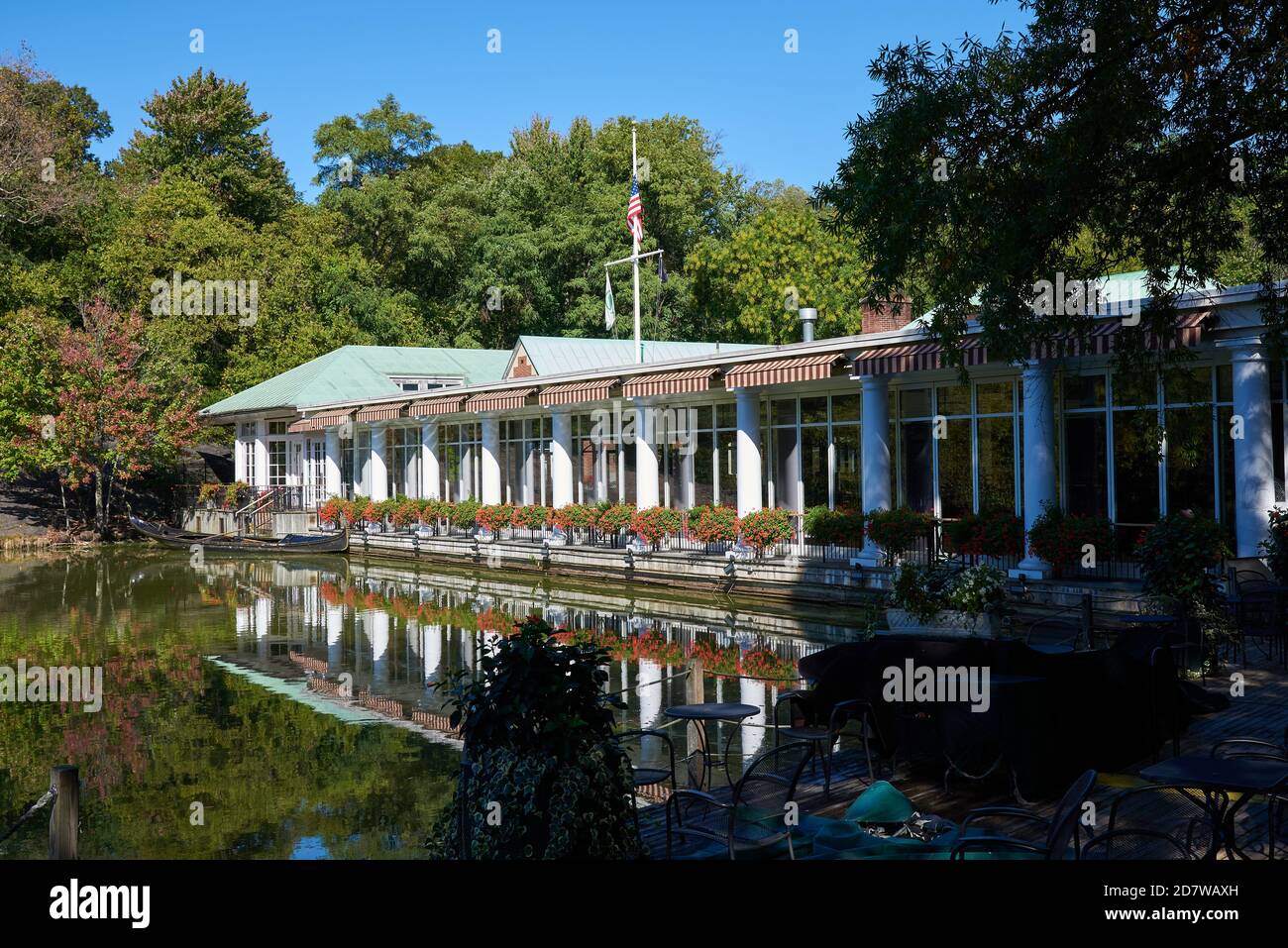 The Loeb Boathouse reflects in the still water of The Lake in Central ...