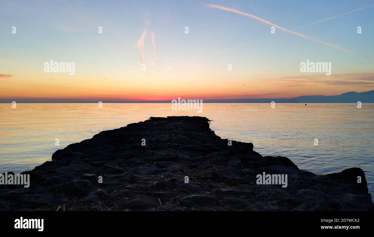 Sunset at Garda lake, Italy. Italian landscape. Pier in perspective ...