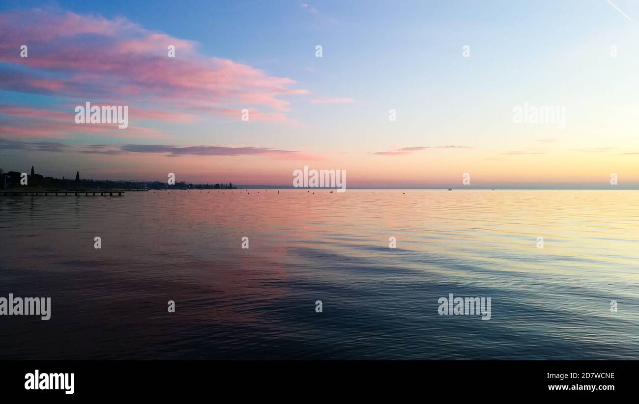 Sunset at Garda lake, Italy. Italian landscape. Pier in perspective ...