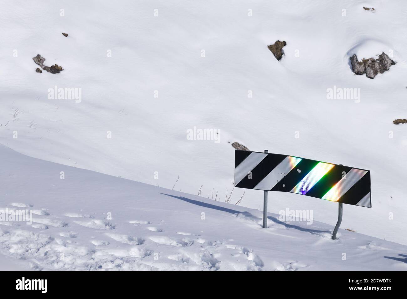 Reflections on traffic sign. Mountain road covered by snow Stock Photo ...