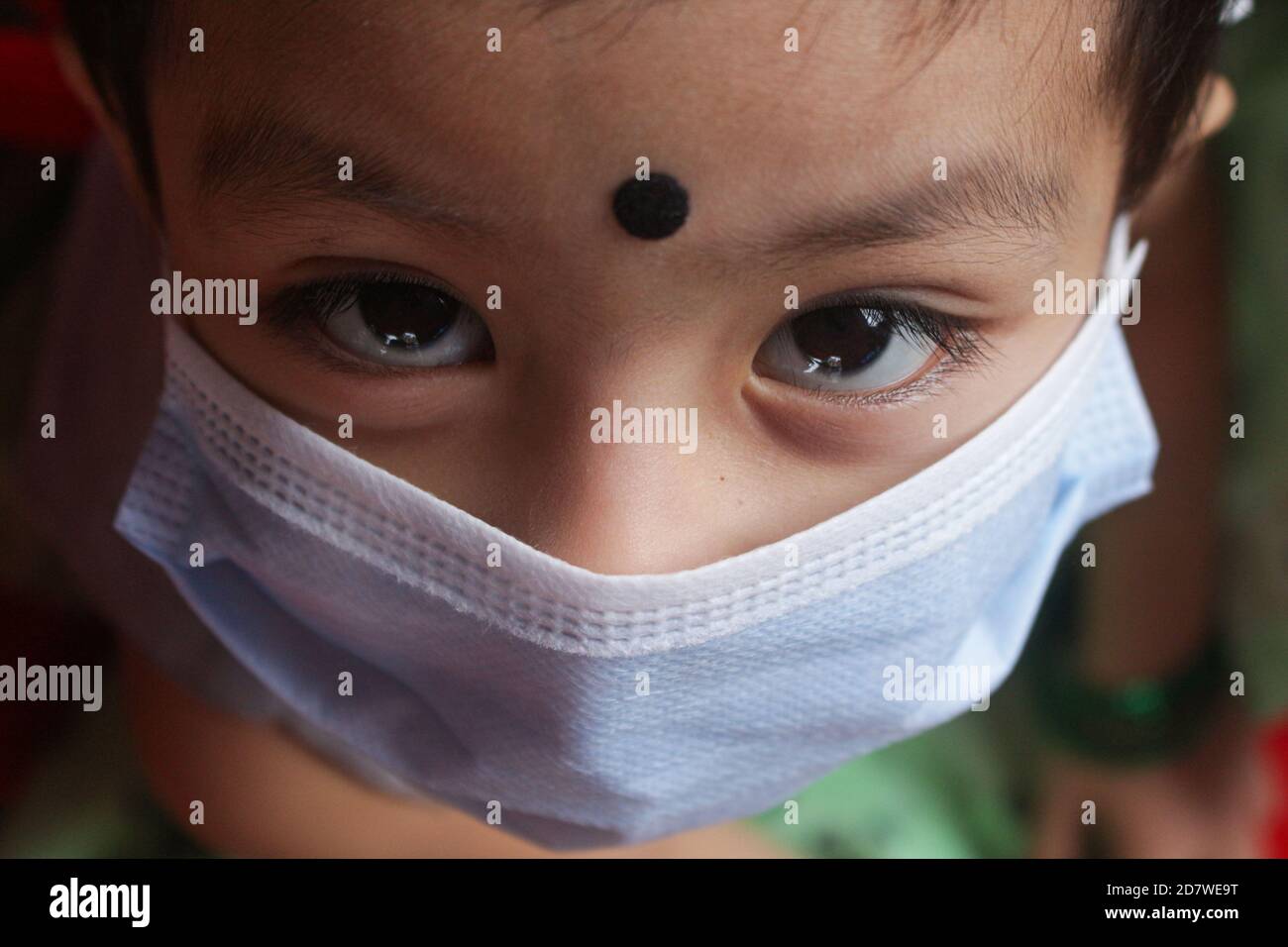 A child wearing a mask at the worship premises. Durga Puja, the main ...