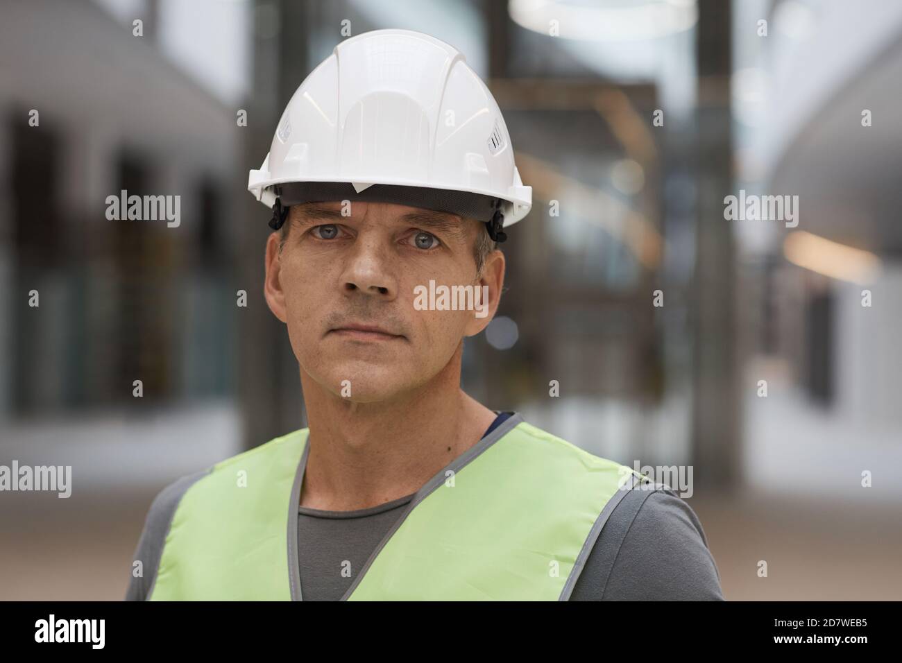 Close up portrait of professional construction worker looking at camera ...