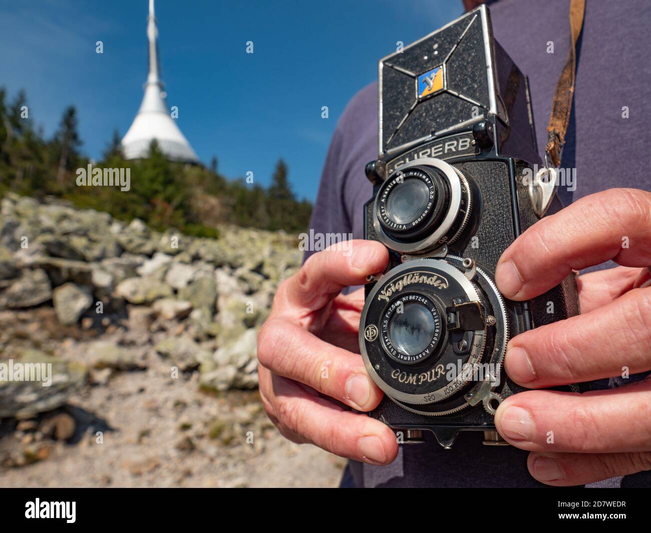 Older photographer man using vintage film camera during trip to Jested ...