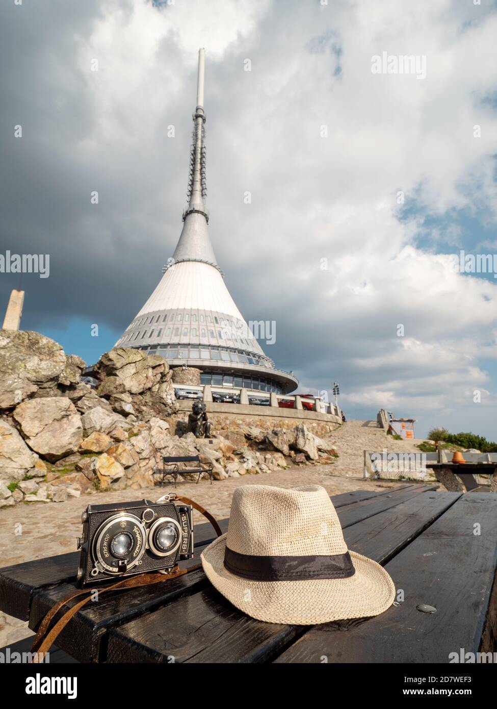 Classic vintage camera and Jested hotel on mountain peak. Summer photo ...