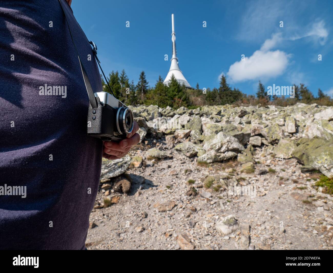 Man takes photo by classic film vintage camera on Jested mountain. The ...