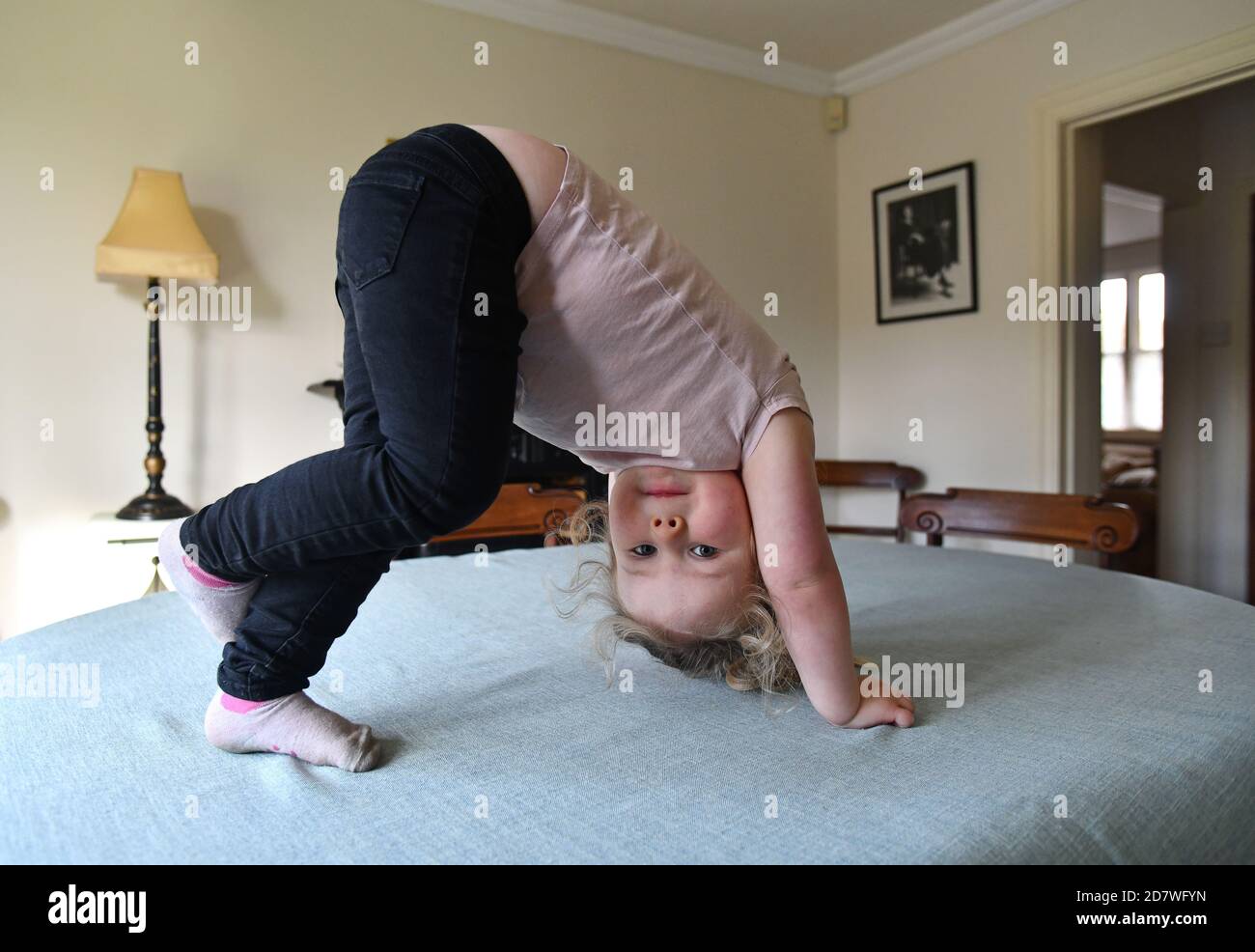 Child young girl doing yoga stretch Stock Photo - Alamy
