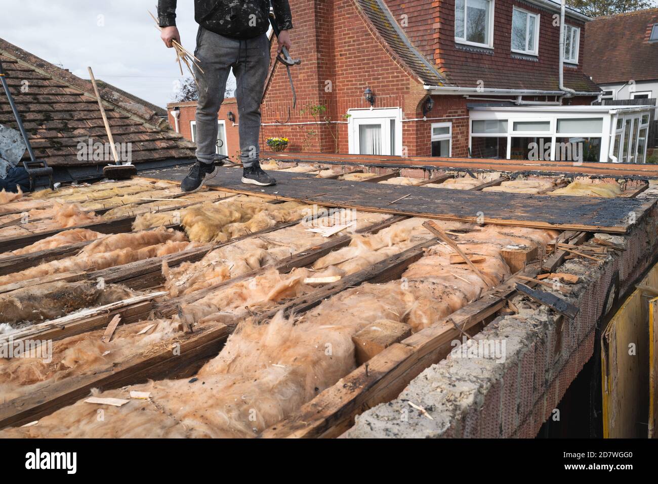 Broken beams exposed on an old flat roof extension after the old roof ...