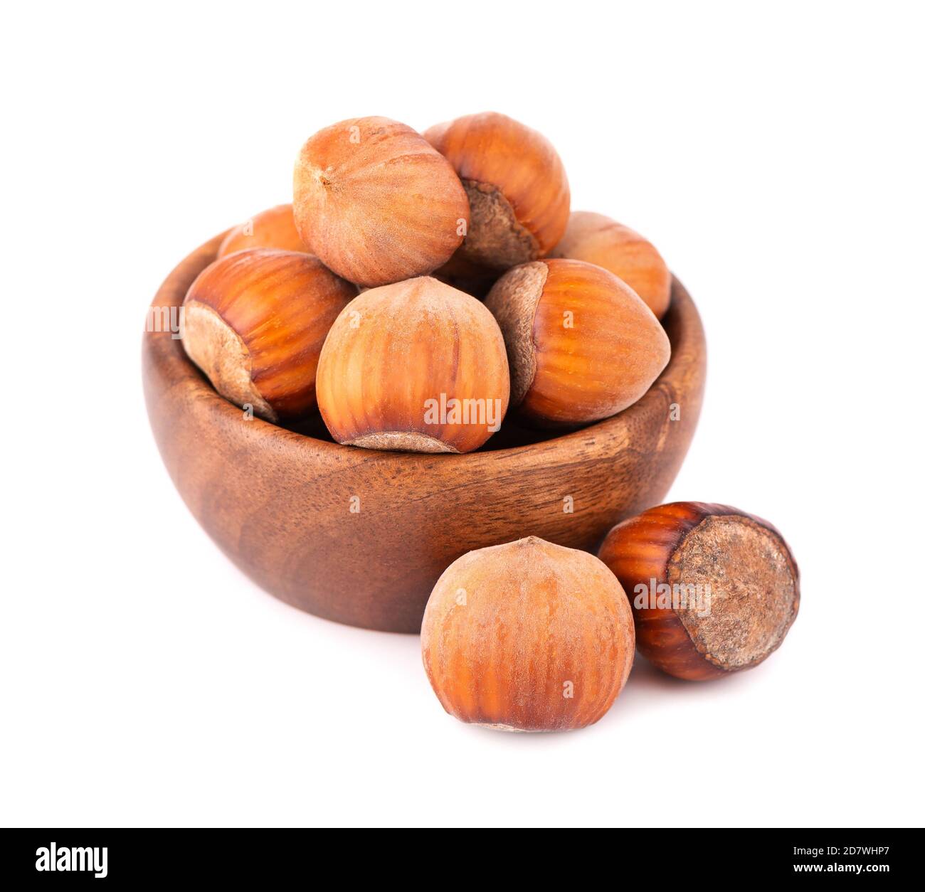 Hazelnut in wooden bowl, isolated on white background. Nut macro. With ...