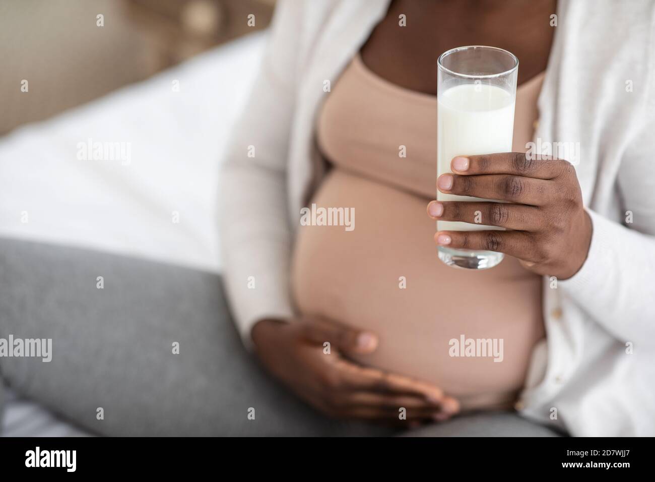 Pregnancy And Calcium. Black Expectant Mother Drinking Milk And ...