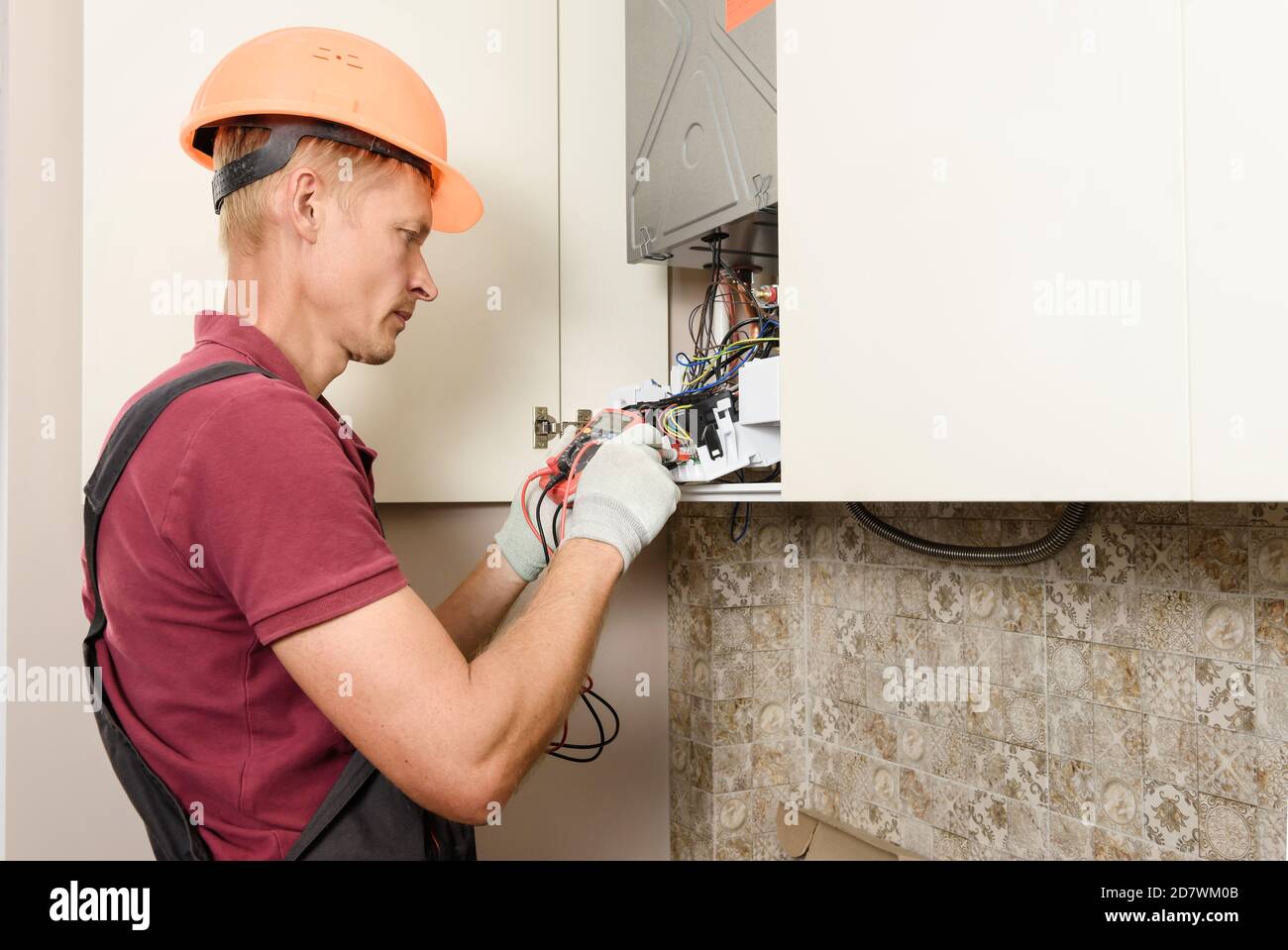 The worker checks the serviceability of the electronics of the gas ...