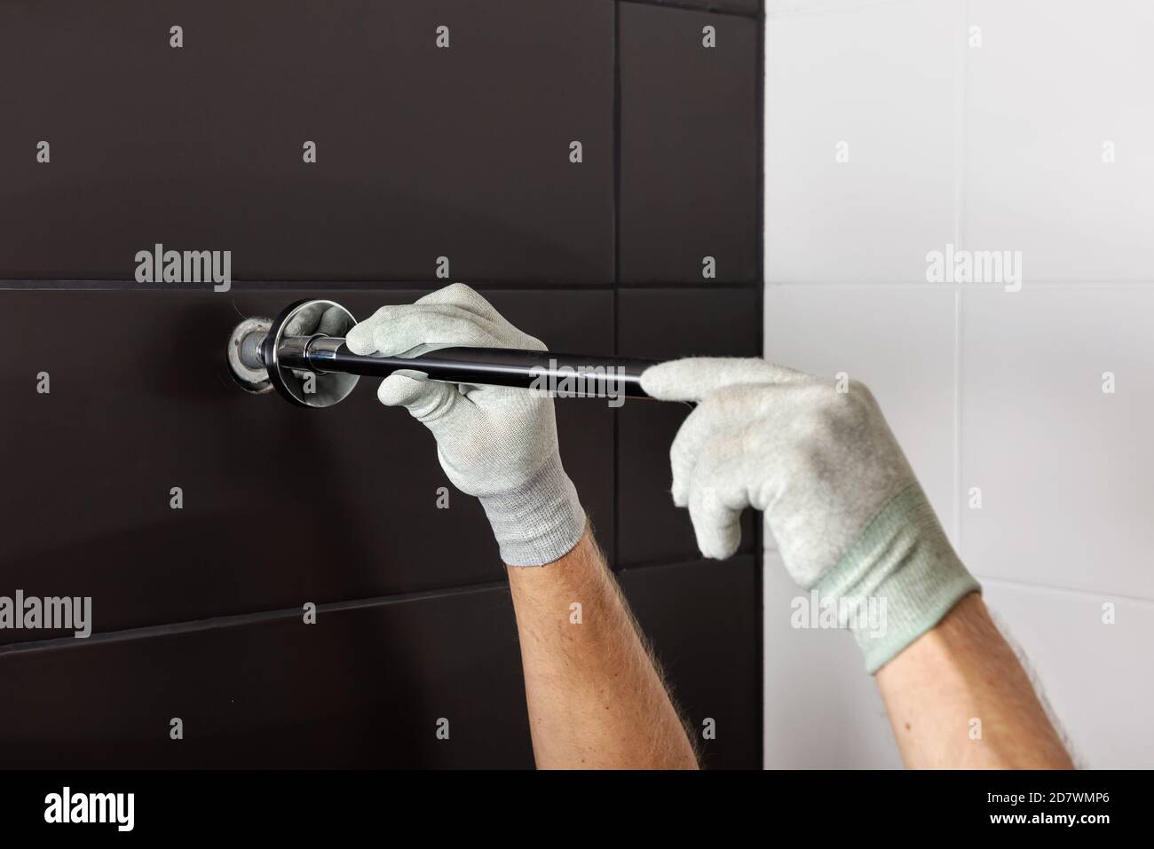 The worker's hands install the tube of the built-in shower faucet Stock ...