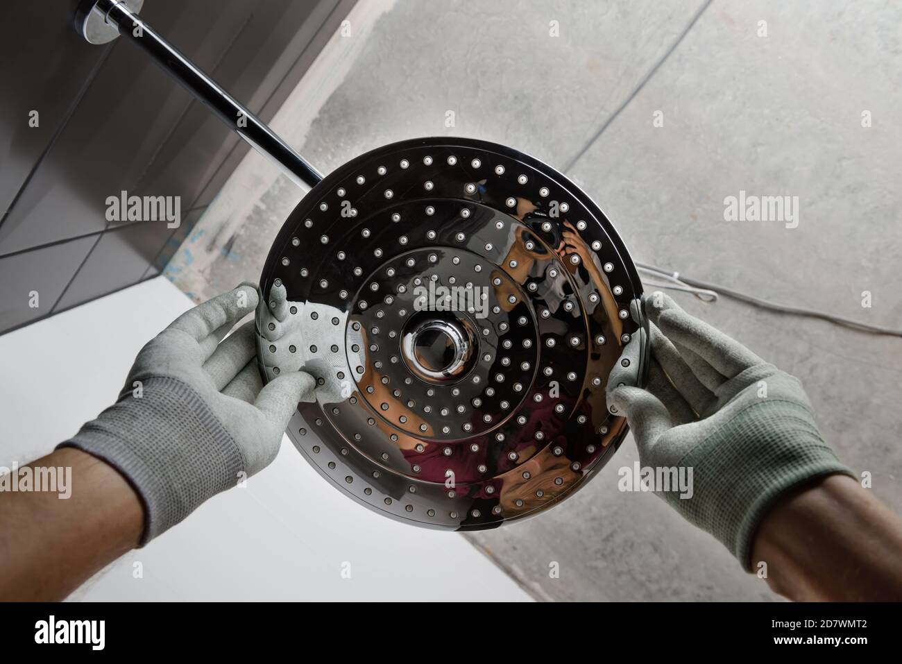 The worker's hands install the head of the built-in shower faucet Stock ...
