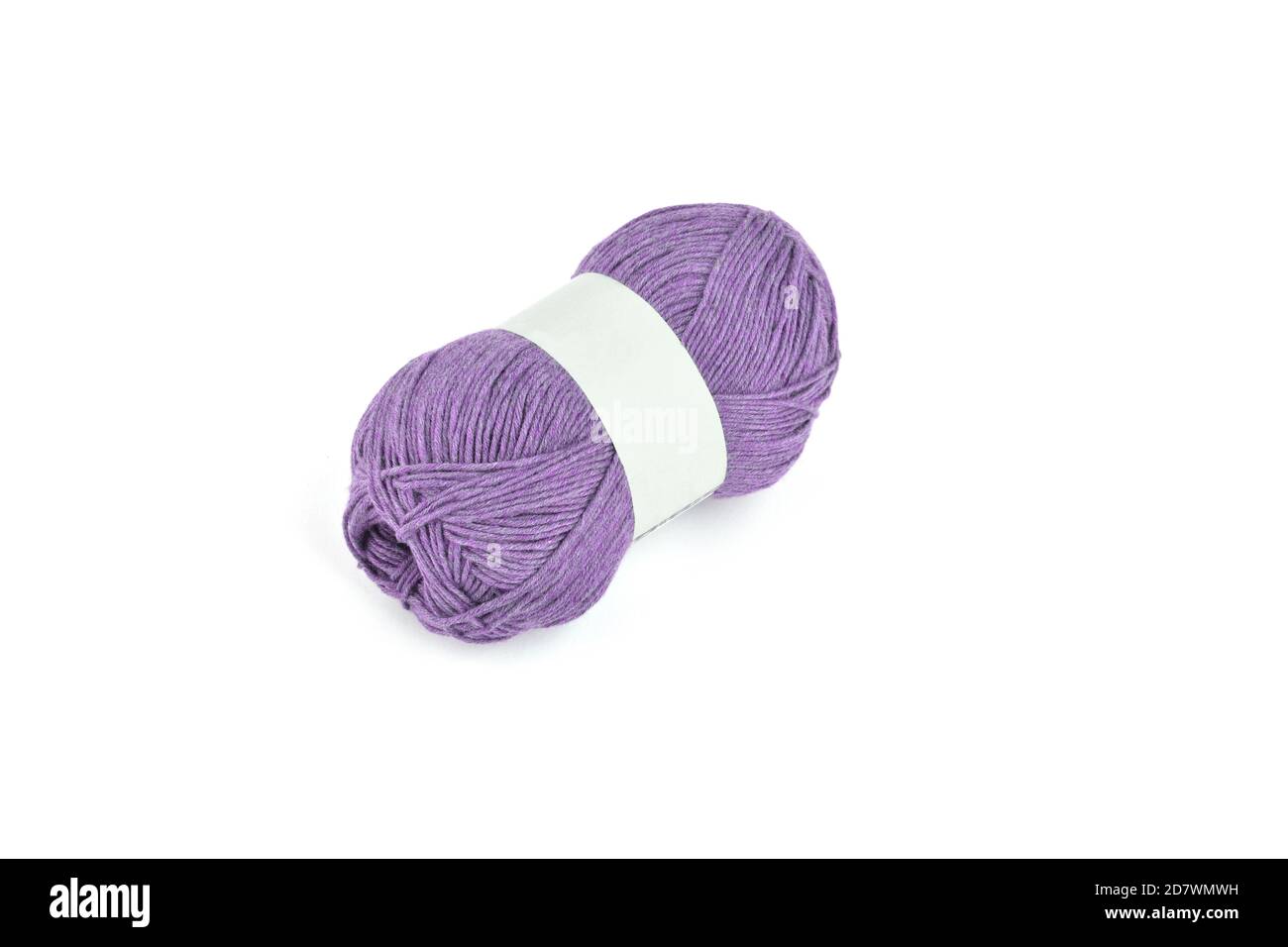 Tangle of purple color yarn with blank label on white background skein ...