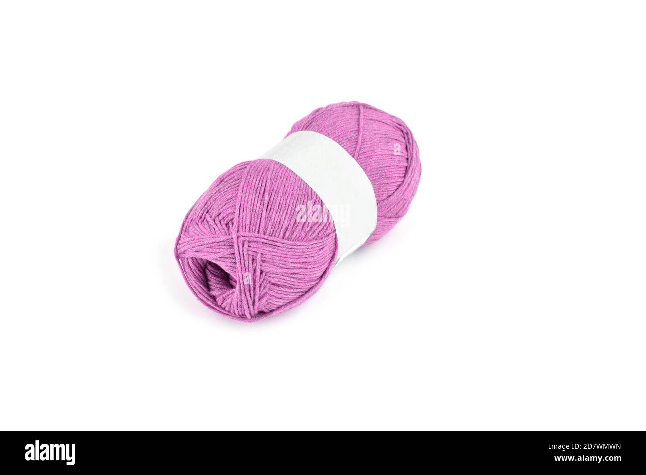 Tangle of pink color yarn with blank label on white background skein ...