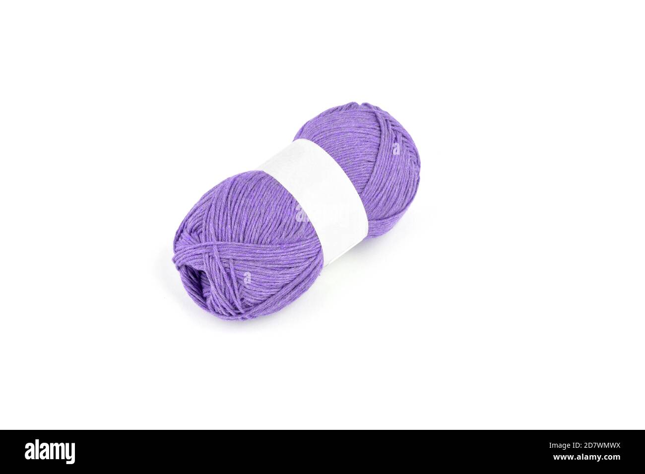 Tangle of purple color yarn with blank label on white background skein ...