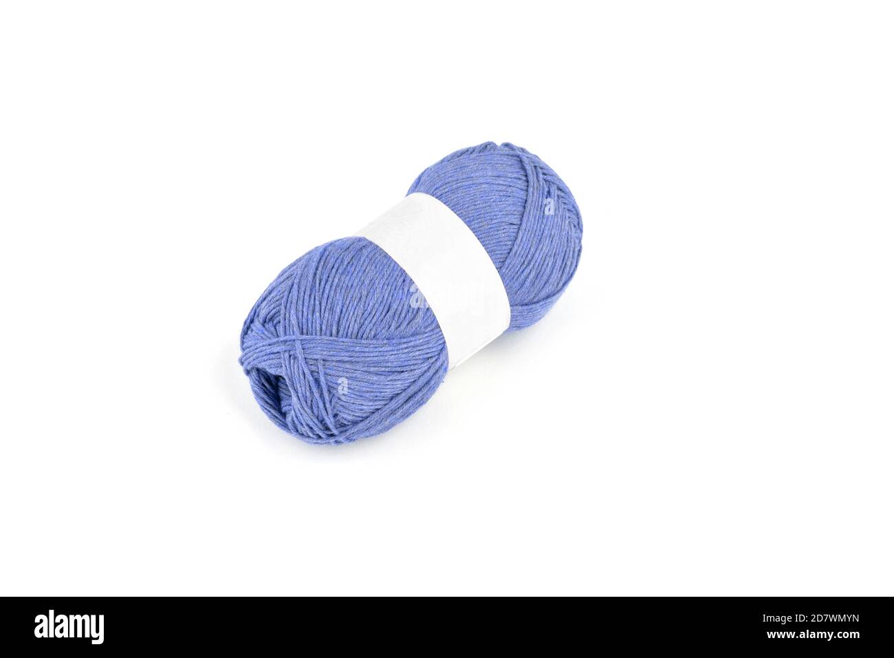 Tangle of blue color yarn with blank label on white background skein ...