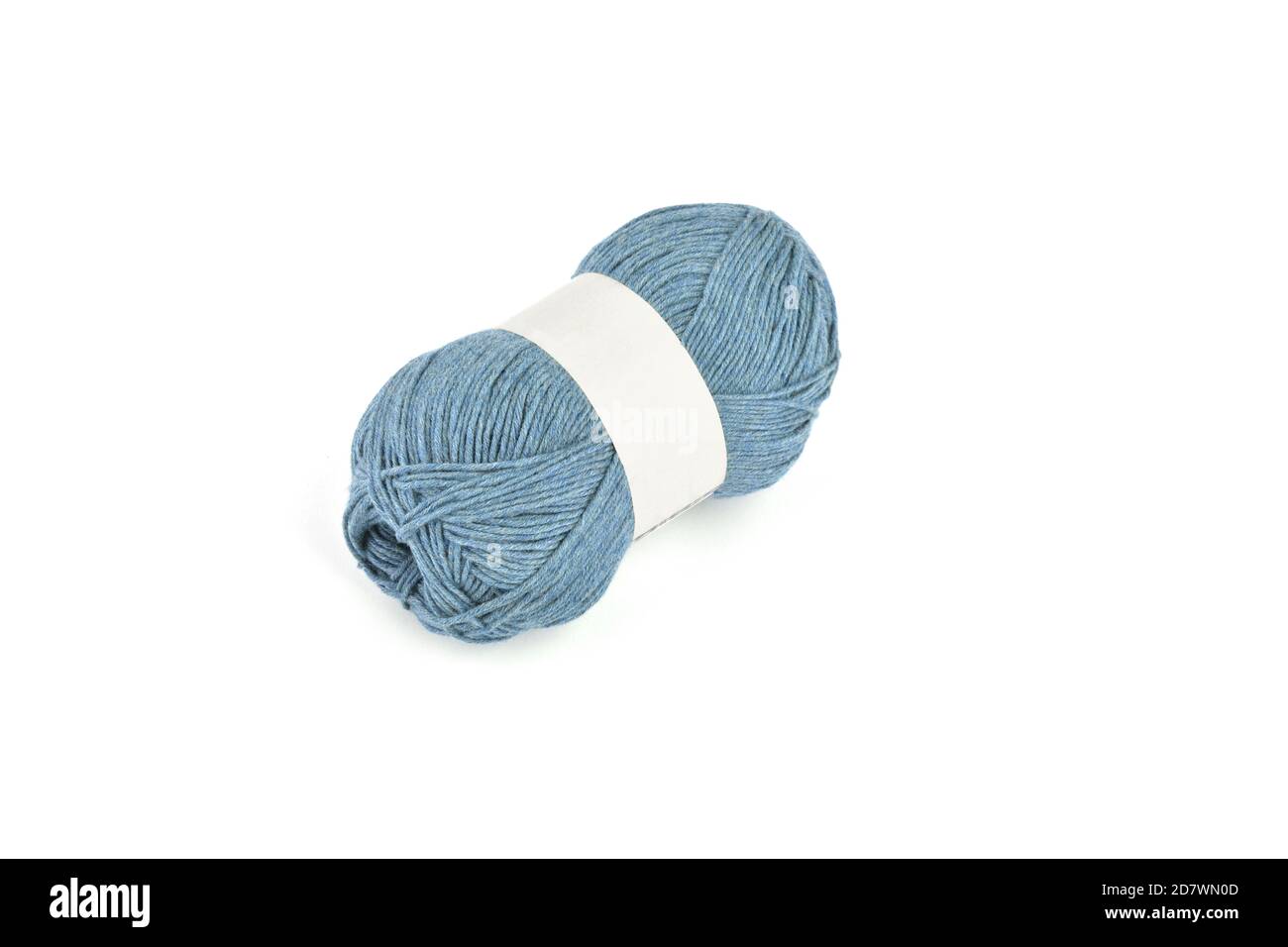 Tangle of blue color yarn with blank label on white background skein ...